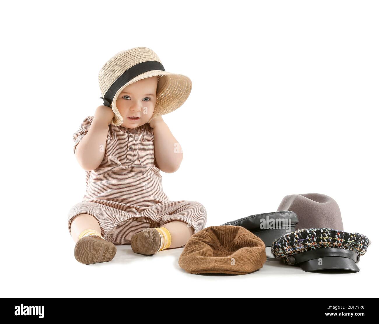 Cute baby with stylish hats on white background Stock Photo - Alamy
