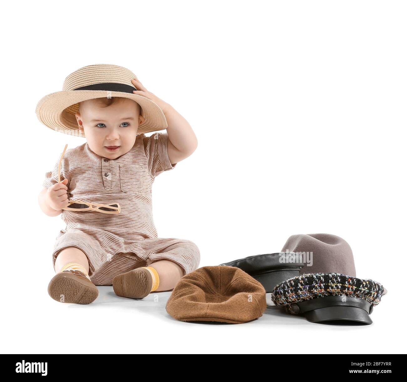 Cute baby with stylish hats on white background Stock Photo - Alamy