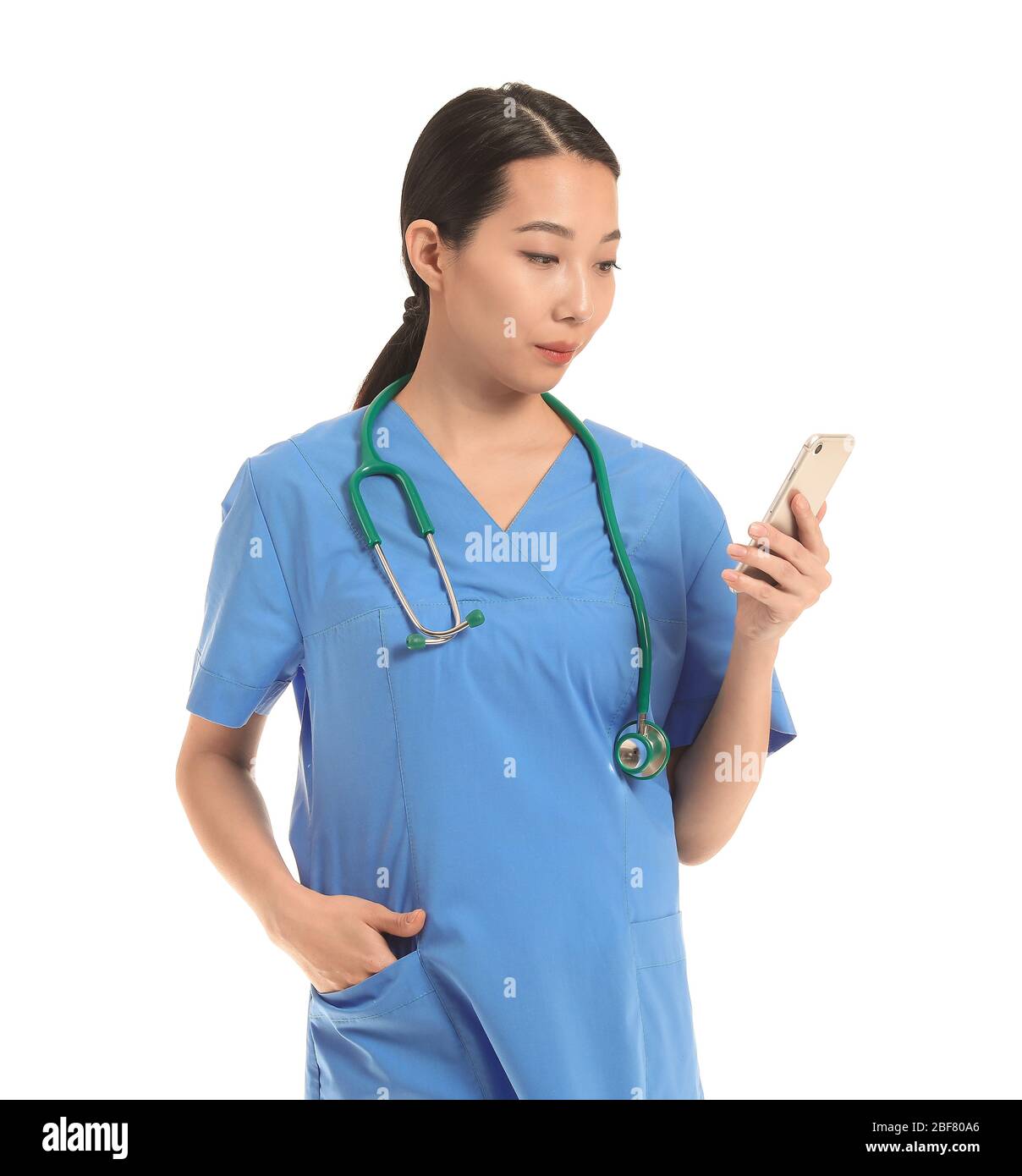 Female Asian doctor with mobile phone on white background Stock Photo ...