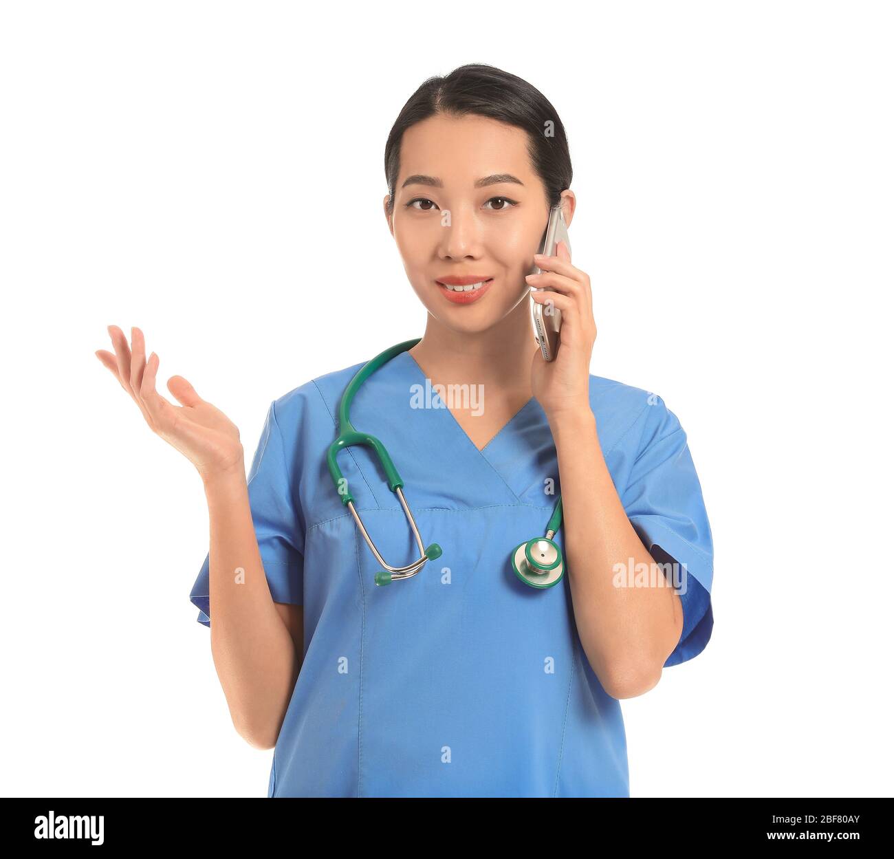 Female Asian doctor talking by phone on white background Stock Photo ...