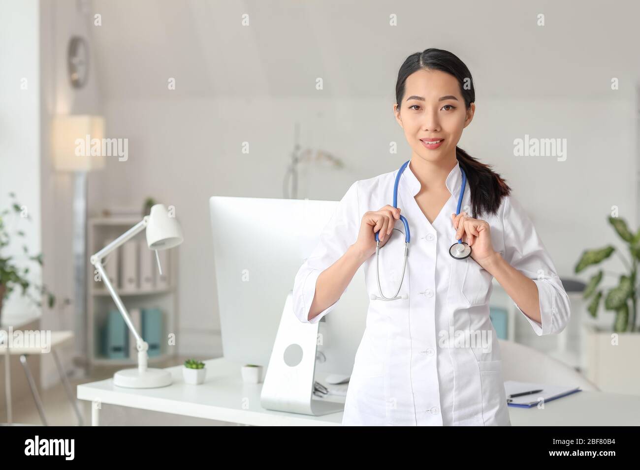 Female Asian doctor in clinic Stock Photo - Alamy