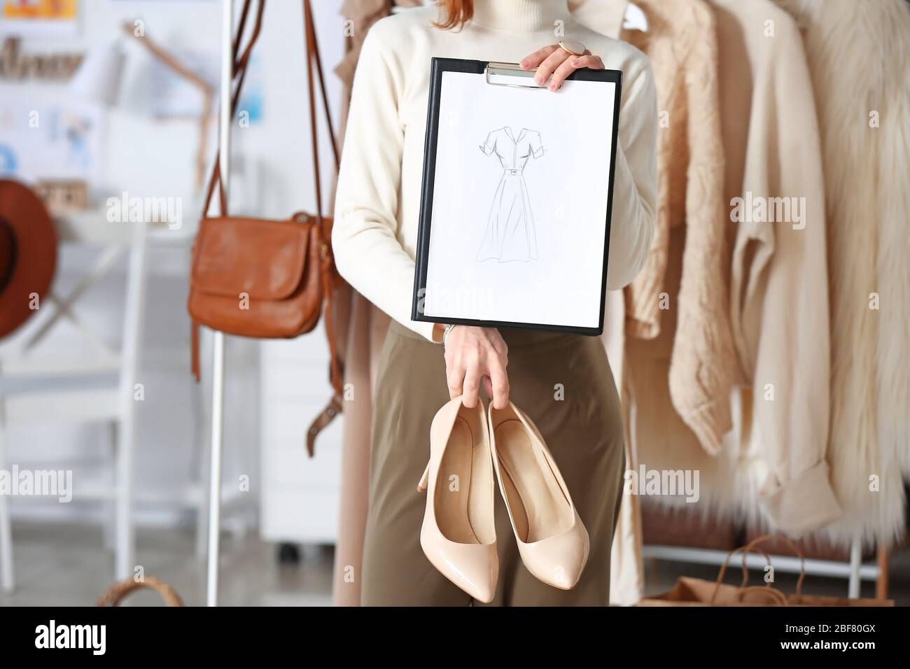 Female stylist with shoes and sketch in her studio Stock Photo - Alamy