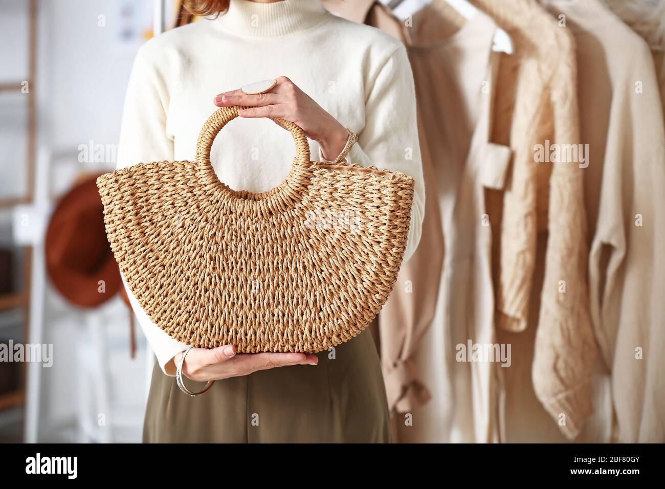 Female stylist with bag in her studio Stock Photo - Alamy