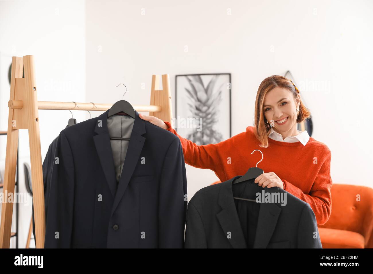 Female stylist with male clothes in her studio Stock Photo - Alamy