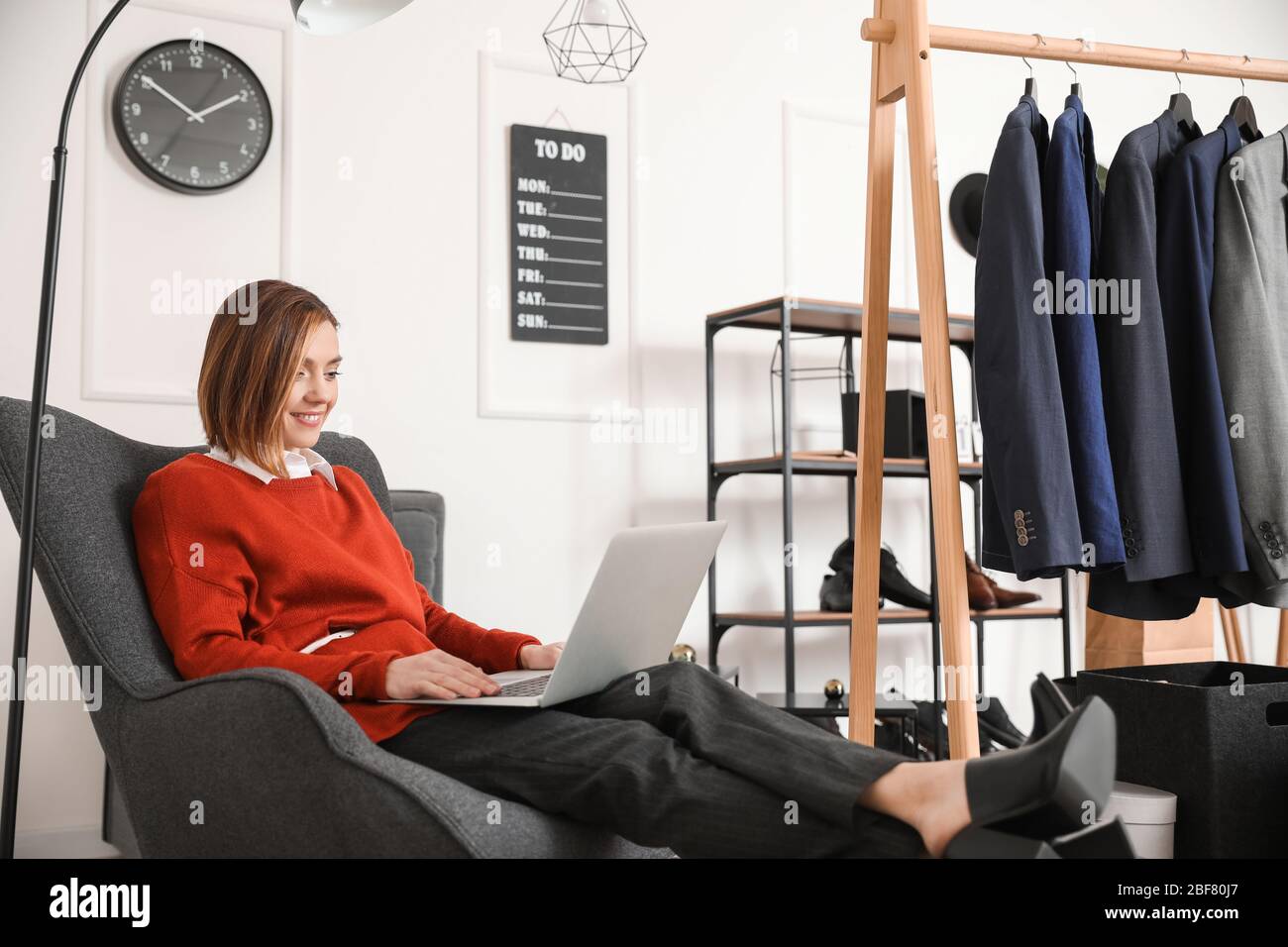 Female stylist with laptop in her studio Stock Photo - Alamy