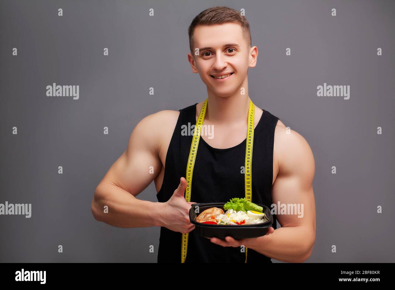 Man holding a box full of protein rich foods for sports nutrition Stock ...