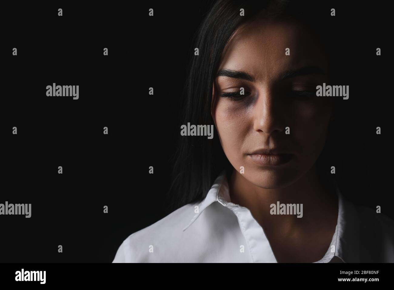 Scared female victim on dark background. Concept of violence Stock ...