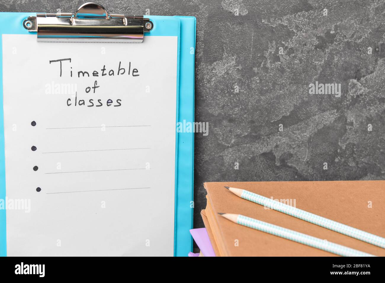 Timetable of classes and books on grey background Stock Photo - Alamy