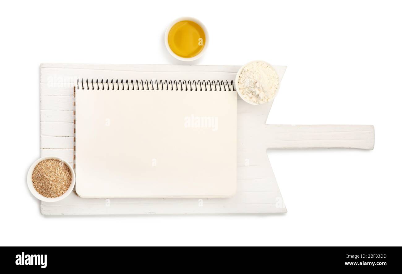 Cook book with products on white background Stock Photo - Alamy