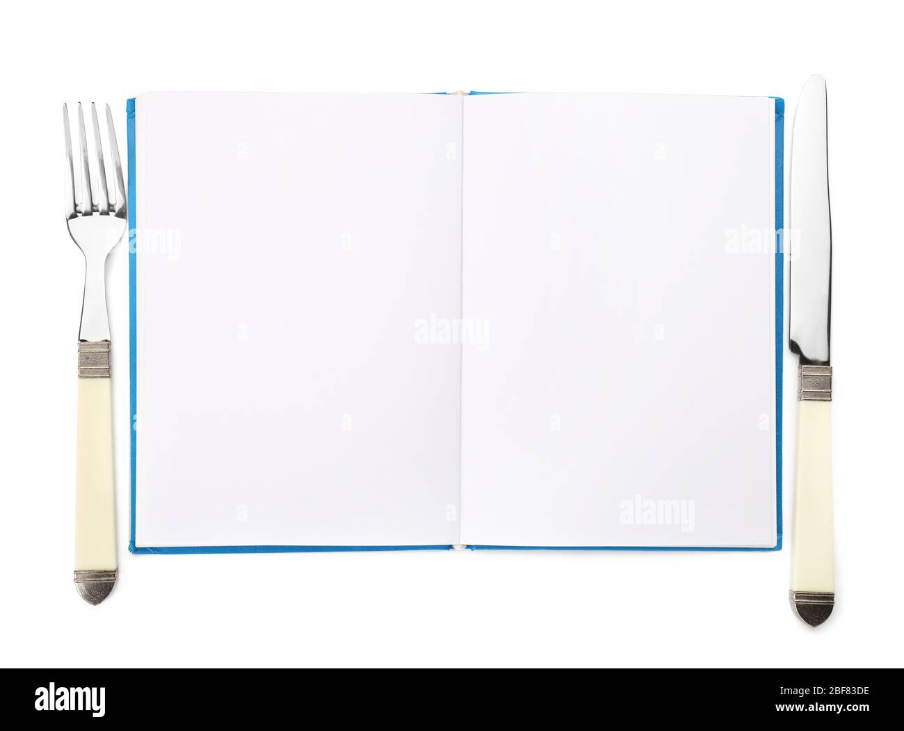 Cook book with cutlery on white background Stock Photo - Alamy