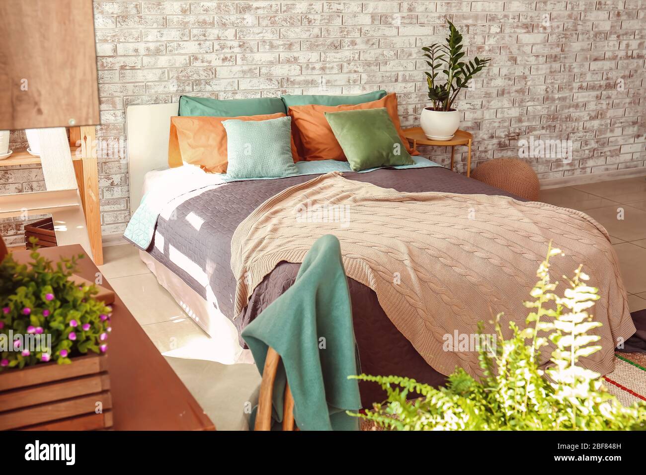 Interior of beautiful modern room with comfortable bed Stock Photo - Alamy