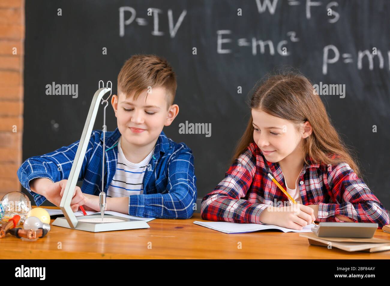 Cute little children at physics lesson in classroom Stock Photo - Alamy