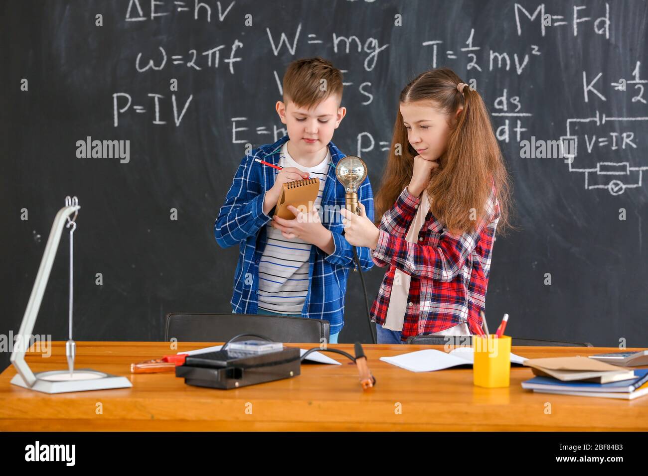 Cute little children at physics lesson in classroom Stock Photo - Alamy