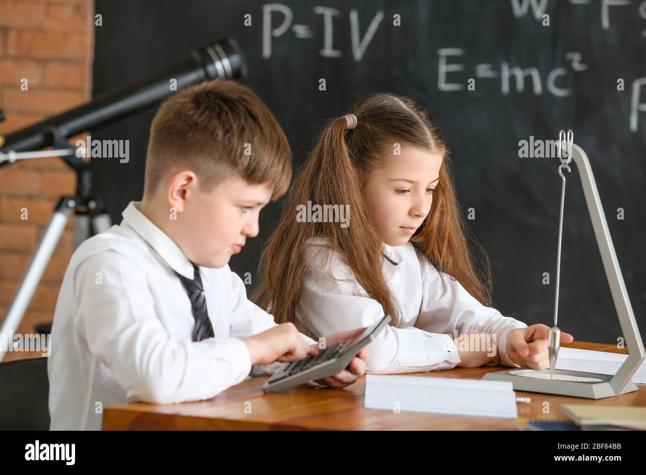 Cute little children at physics lesson in classroom Stock Photo - Alamy
