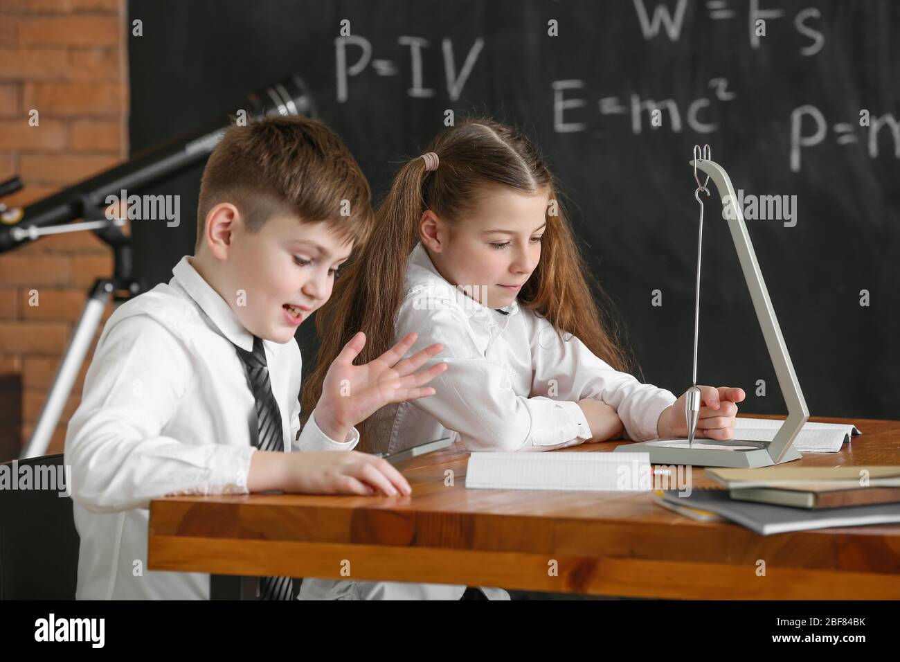 Cute little children at physics lesson in classroom Stock Photo - Alamy