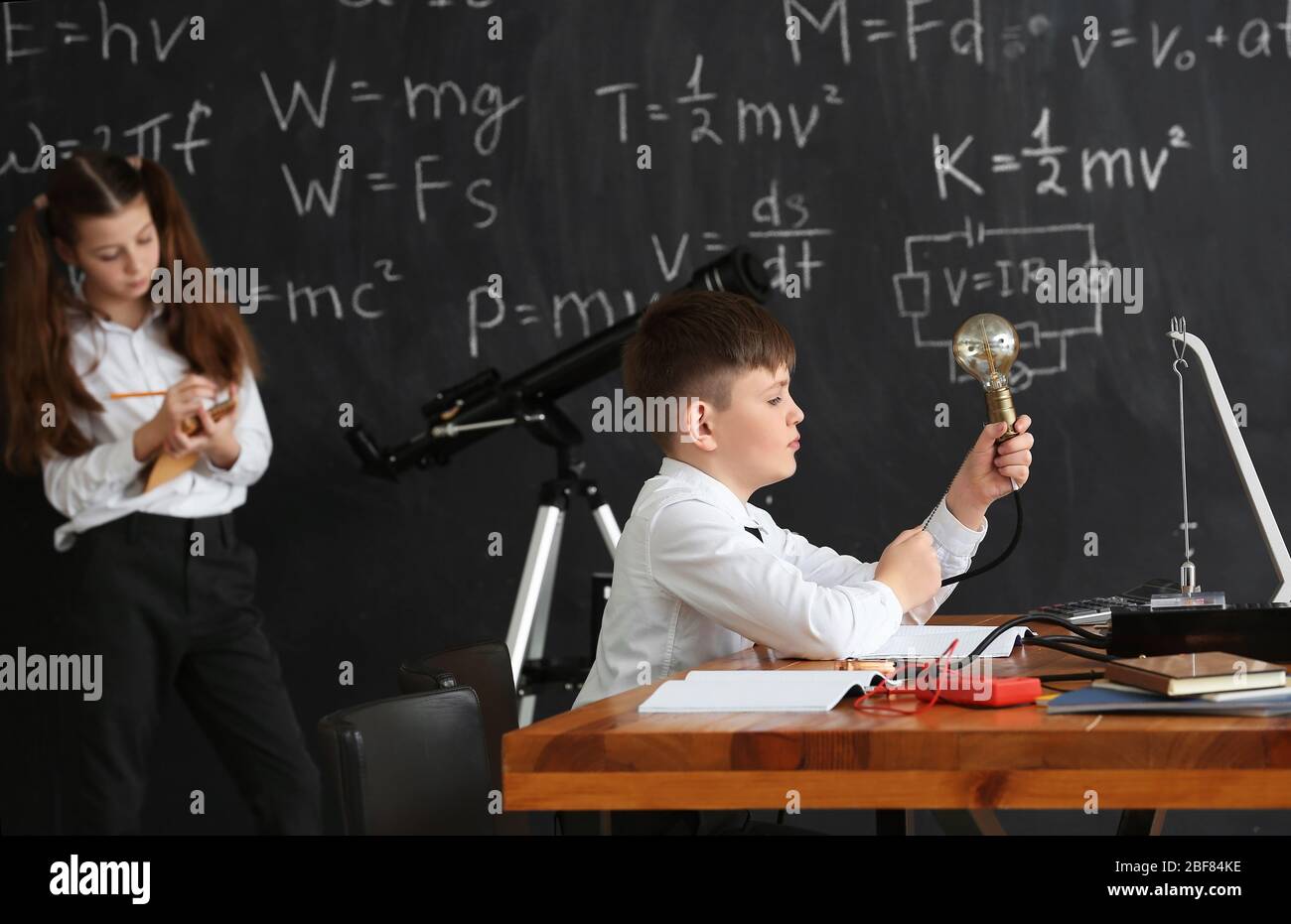 Cute little boy at physics lesson in classroom Stock Photo - Alamy