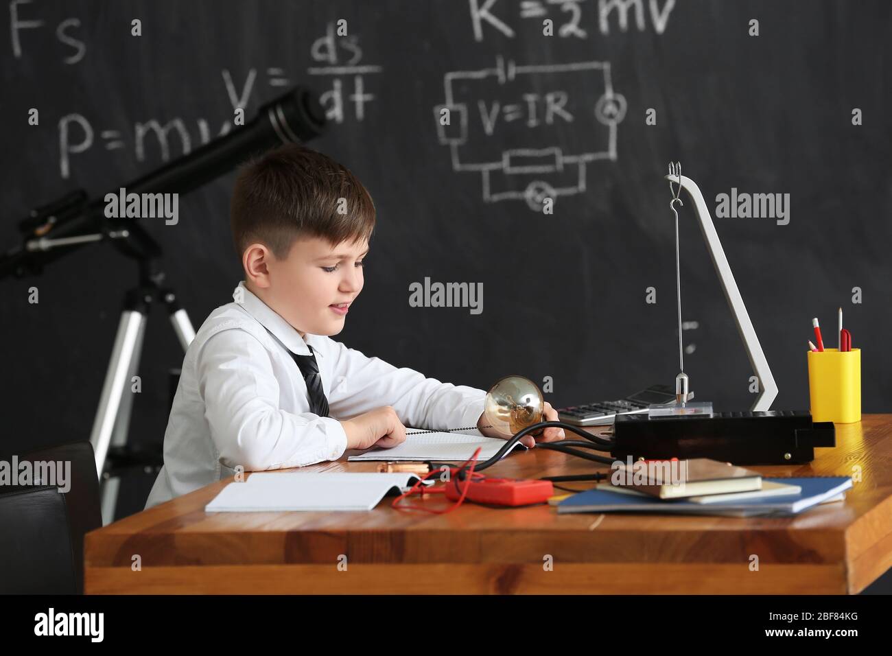 Cute little boy at physics lesson in classroom Stock Photo - Alamy