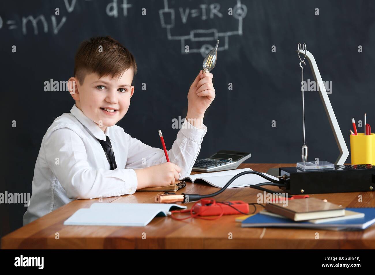 Cute little boy at physics lesson in classroom Stock Photo - Alamy