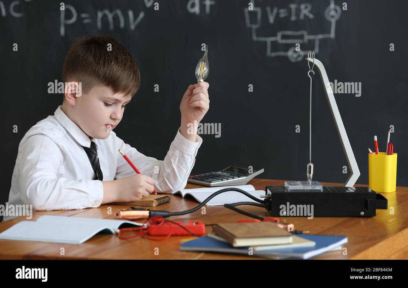 Cute little boy at physics lesson in classroom Stock Photo - Alamy
