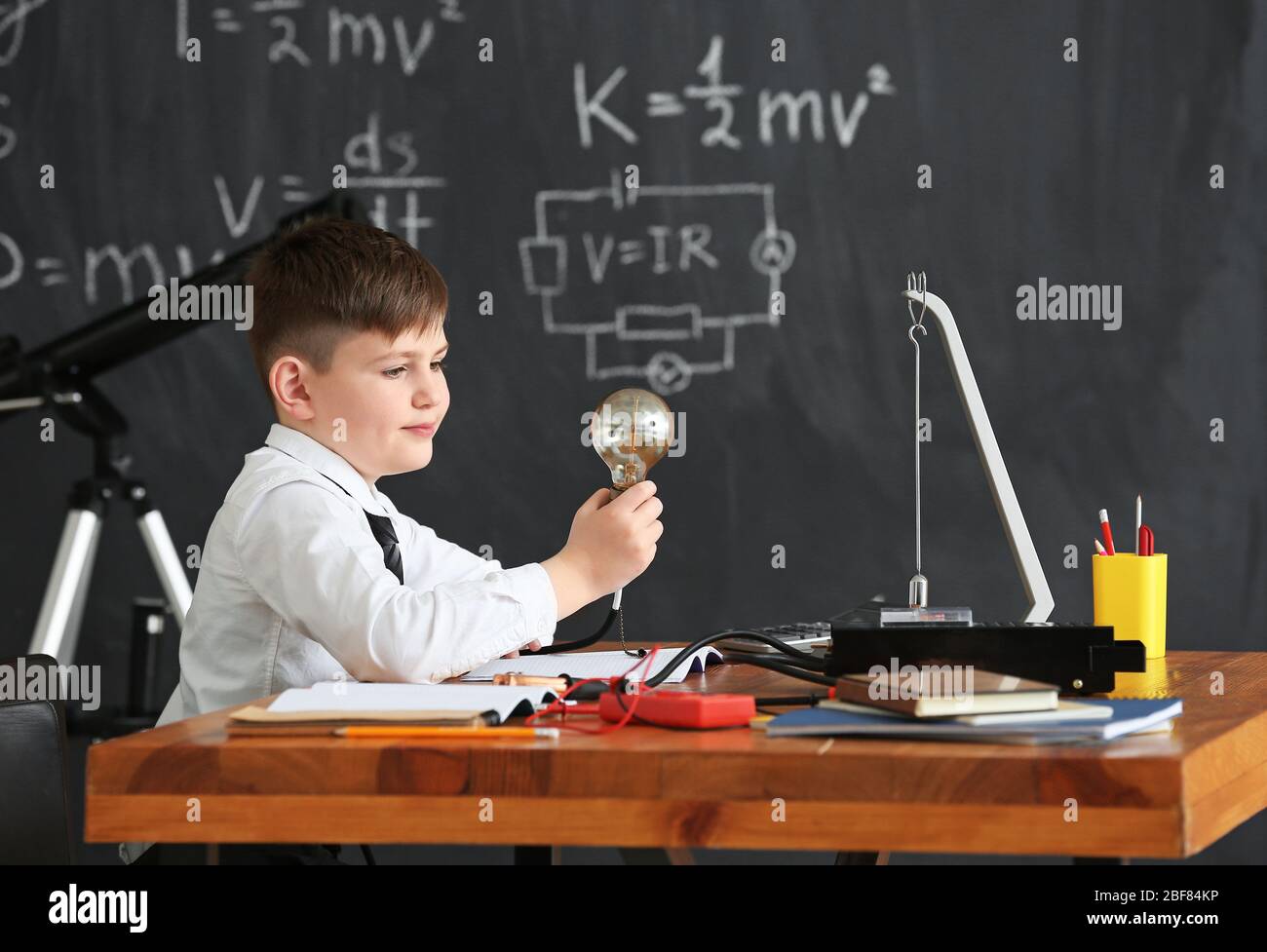 Cute little boy at physics lesson in classroom Stock Photo - Alamy