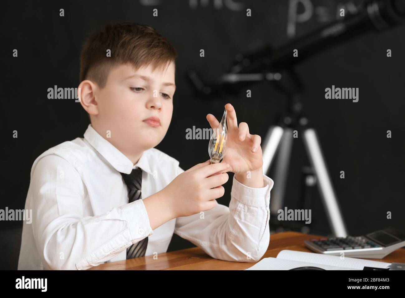 Cute little boy at physics lesson in classroom Stock Photo - Alamy