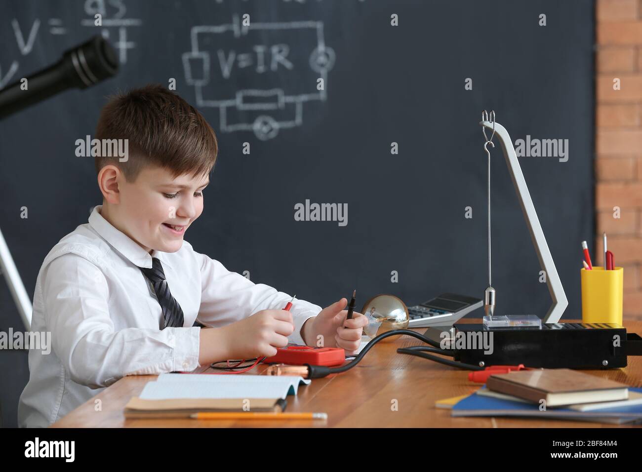Cute little boy at physics lesson in classroom Stock Photo - Alamy