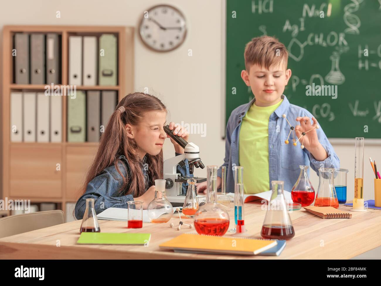 Cute little children at chemistry lesson in classroom Stock Photo - Alamy