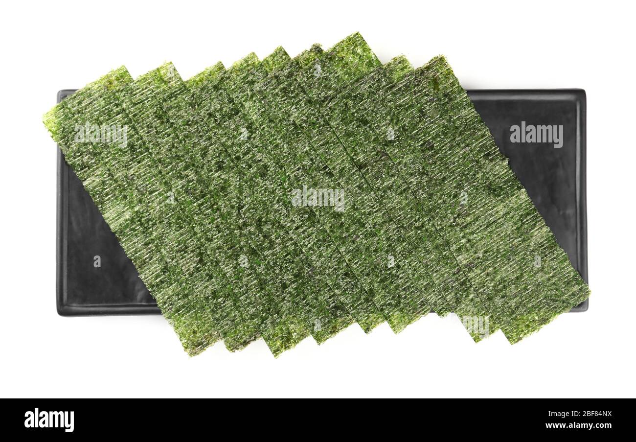 Tasty seaweed sheets on white background Stock Photo - Alamy