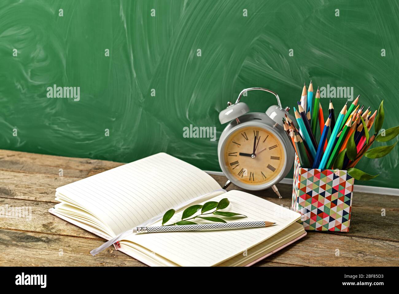 Set of school supplies and clock on table. Time to study Stock Photo ...
