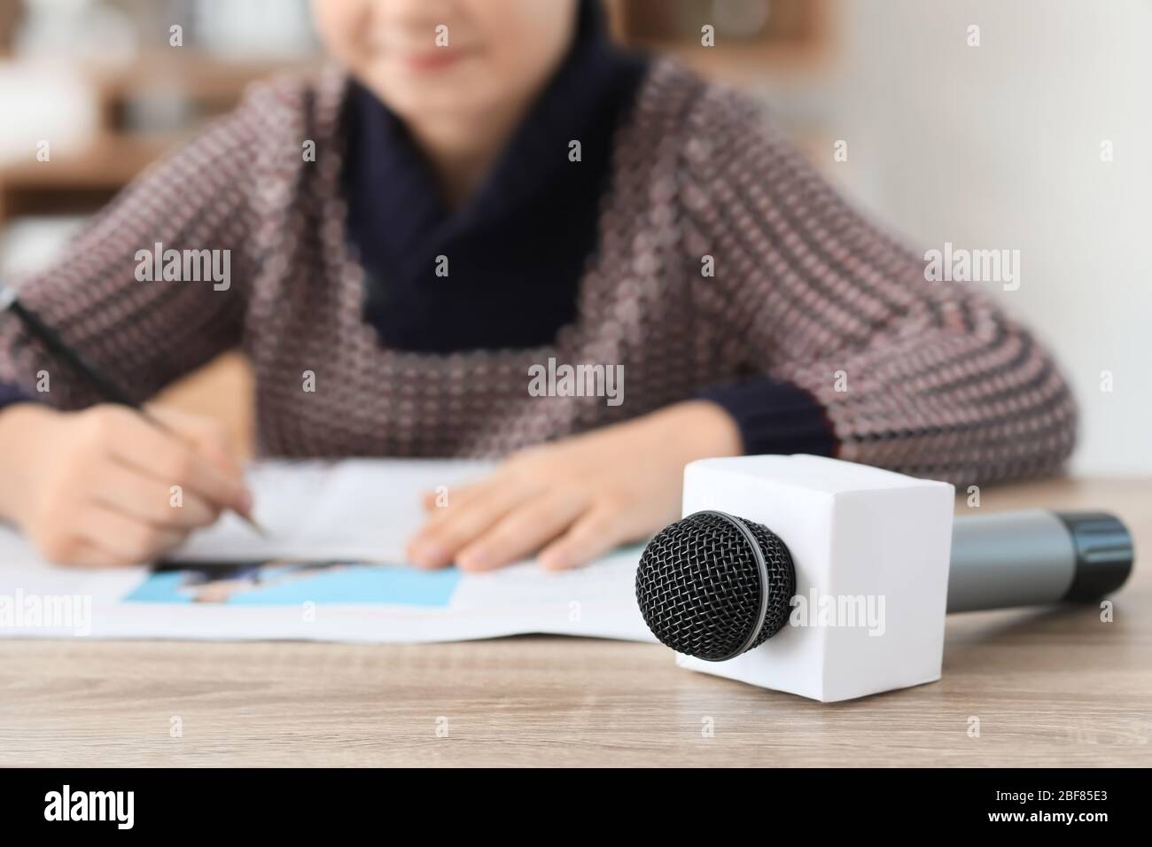 Little journalist working in office Stock Photo - Alamy