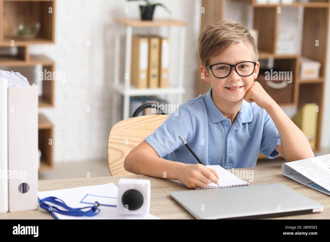 Little journalist working in office Stock Photo - Alamy