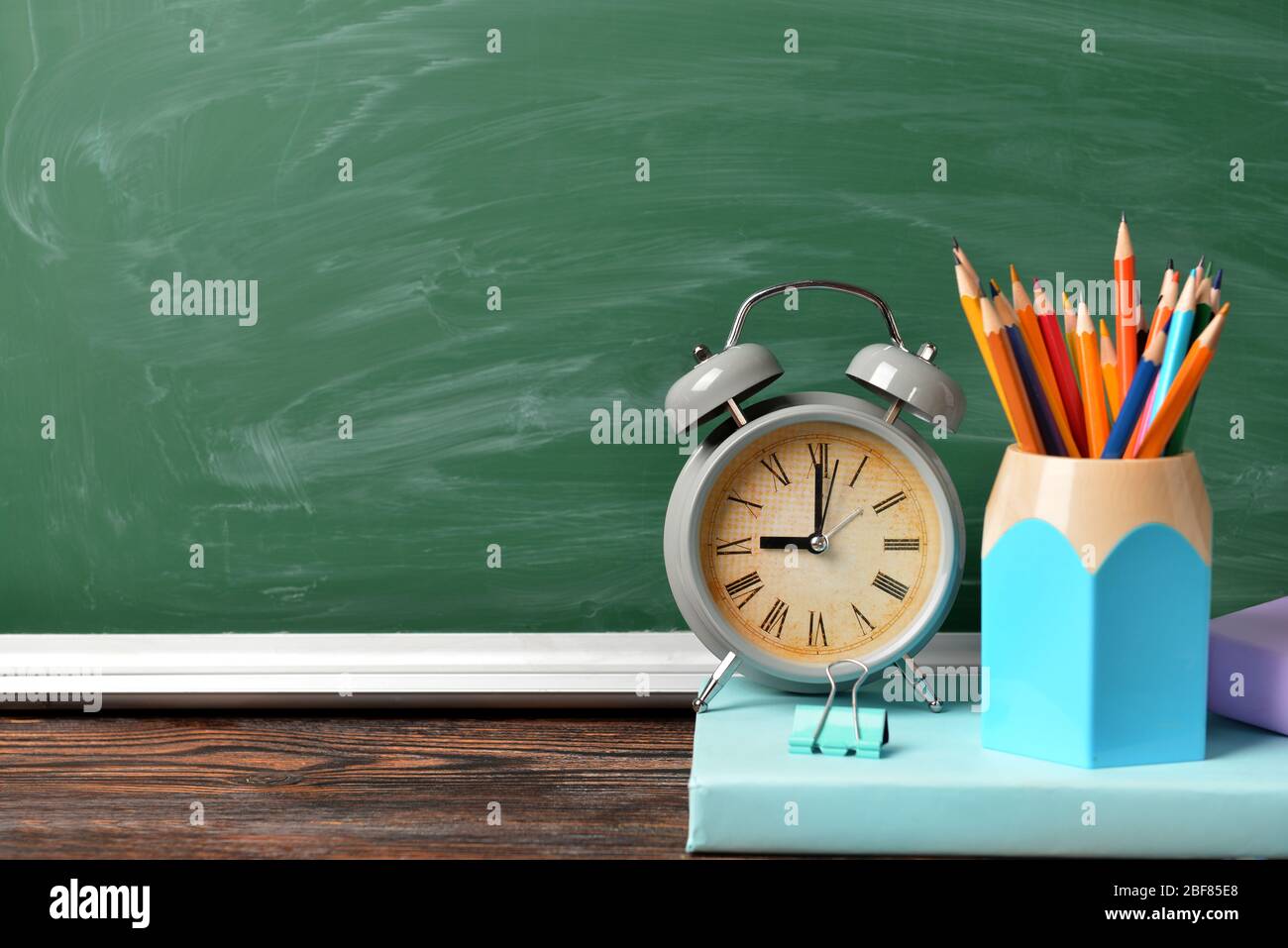 Set of school supplies and clock on table. Time to study Stock Photo ...