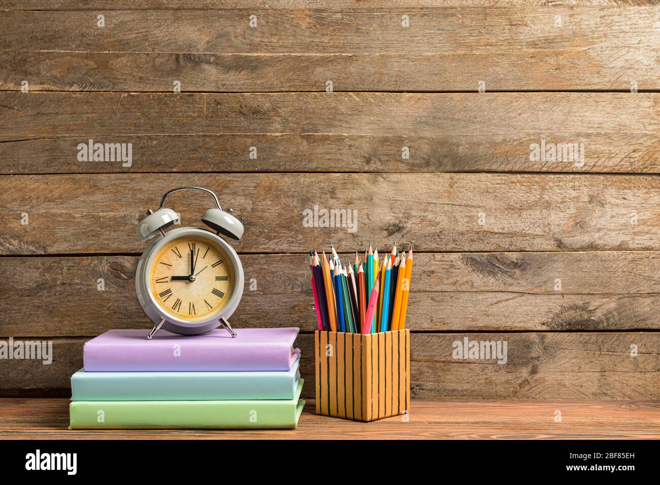 Set of school supplies and clock on table. Time to study Stock Photo ...