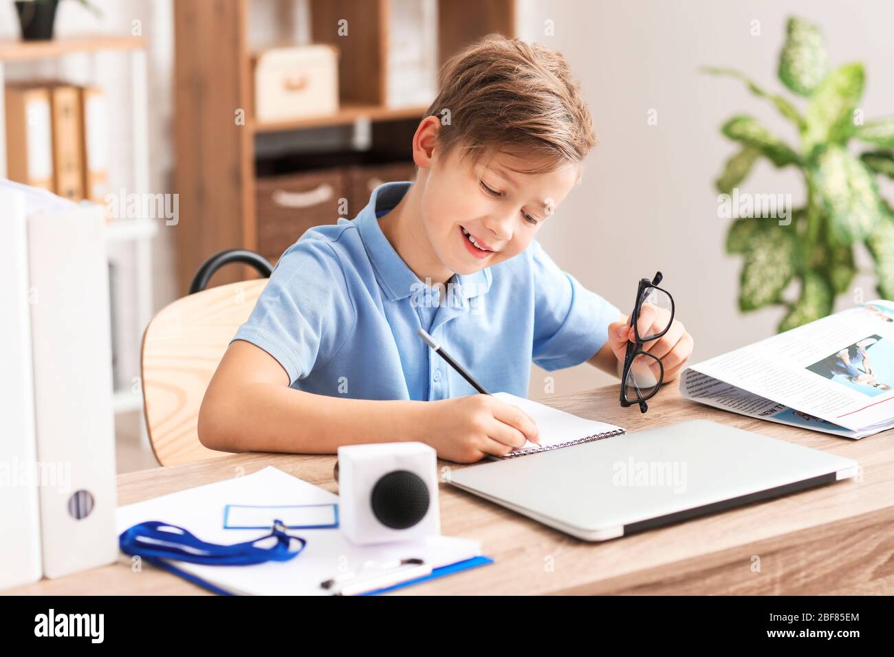 Little journalist working in office Stock Photo - Alamy