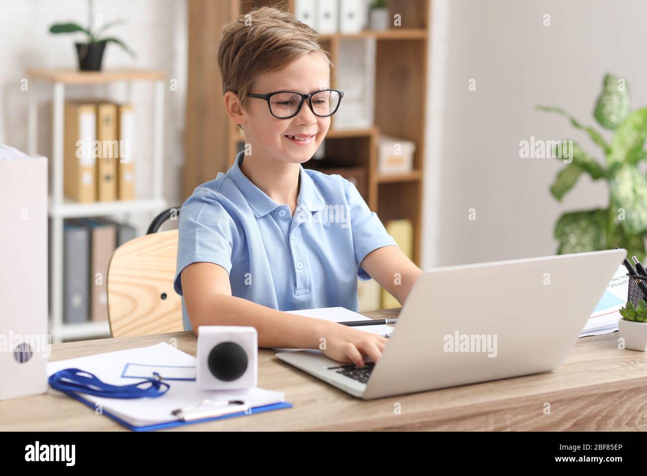 Little journalist working in office Stock Photo - Alamy