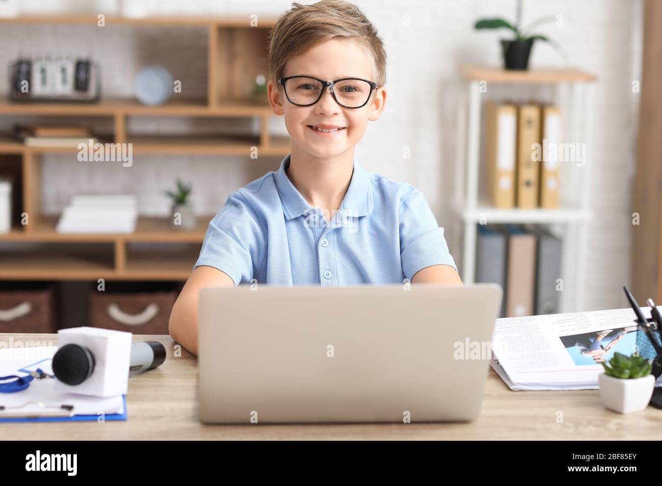 Little journalist working in office Stock Photo - Alamy