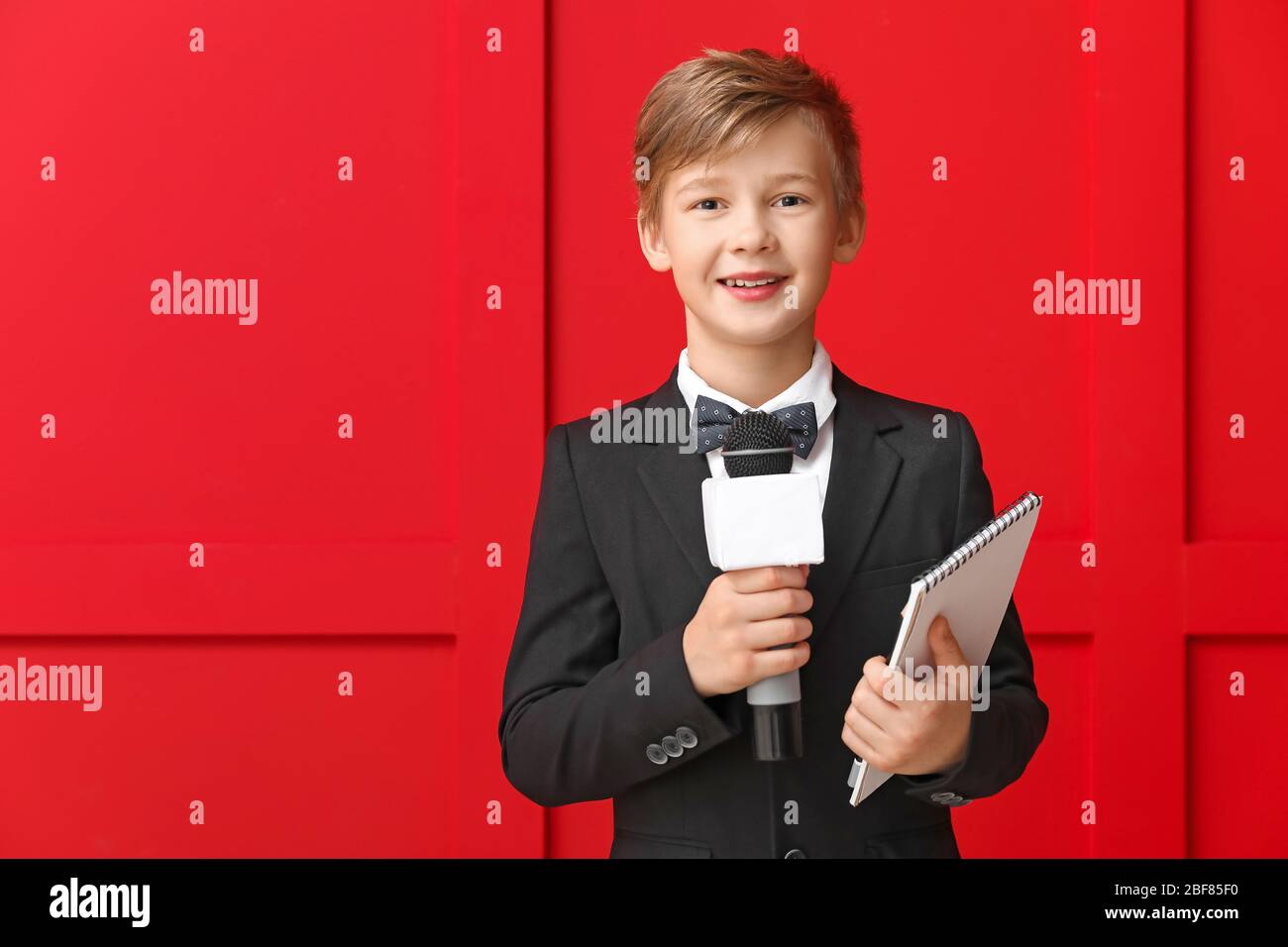 Little journalist with microphone on color background Stock Photo - Alamy