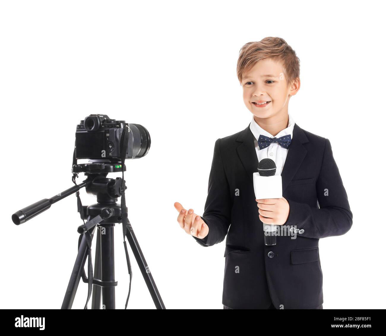 Little journalist with microphone and camera on white background Stock ...