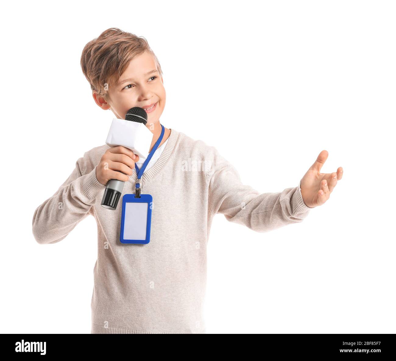 Little journalist with microphone on white background Stock Photo - Alamy