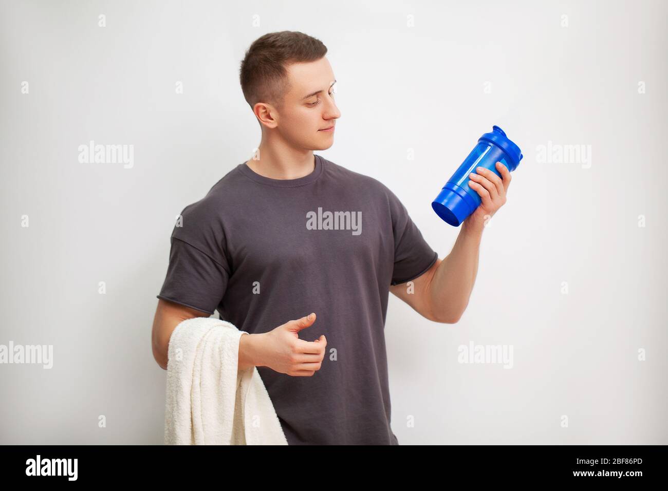 Man prepares a protein shake in the shaker after training Stock Photo ...
