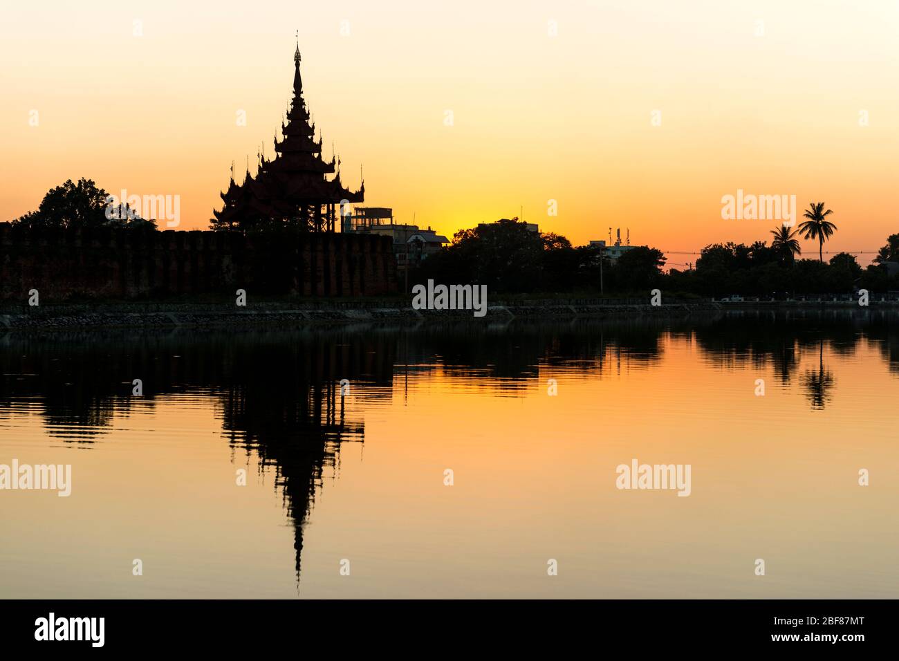 Sunset over the bastion on the northeast corner of the moat of Mandalay ...