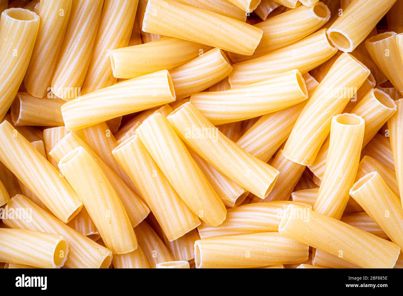 Yellow italian pasta tortiglioni abstract background. Traditional food ...