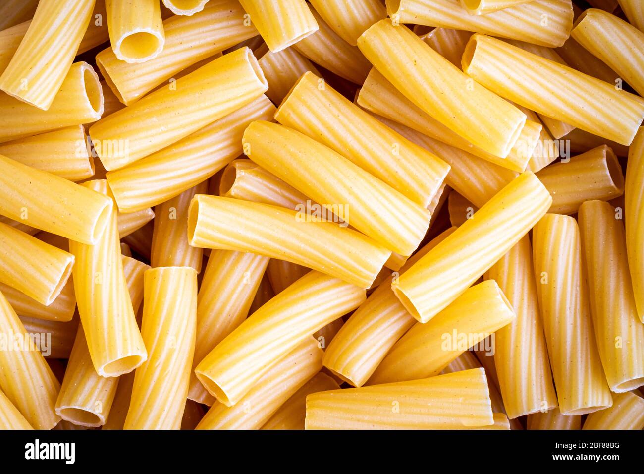 Yellow italian pasta tortiglioni abstract background. Traditional food ...