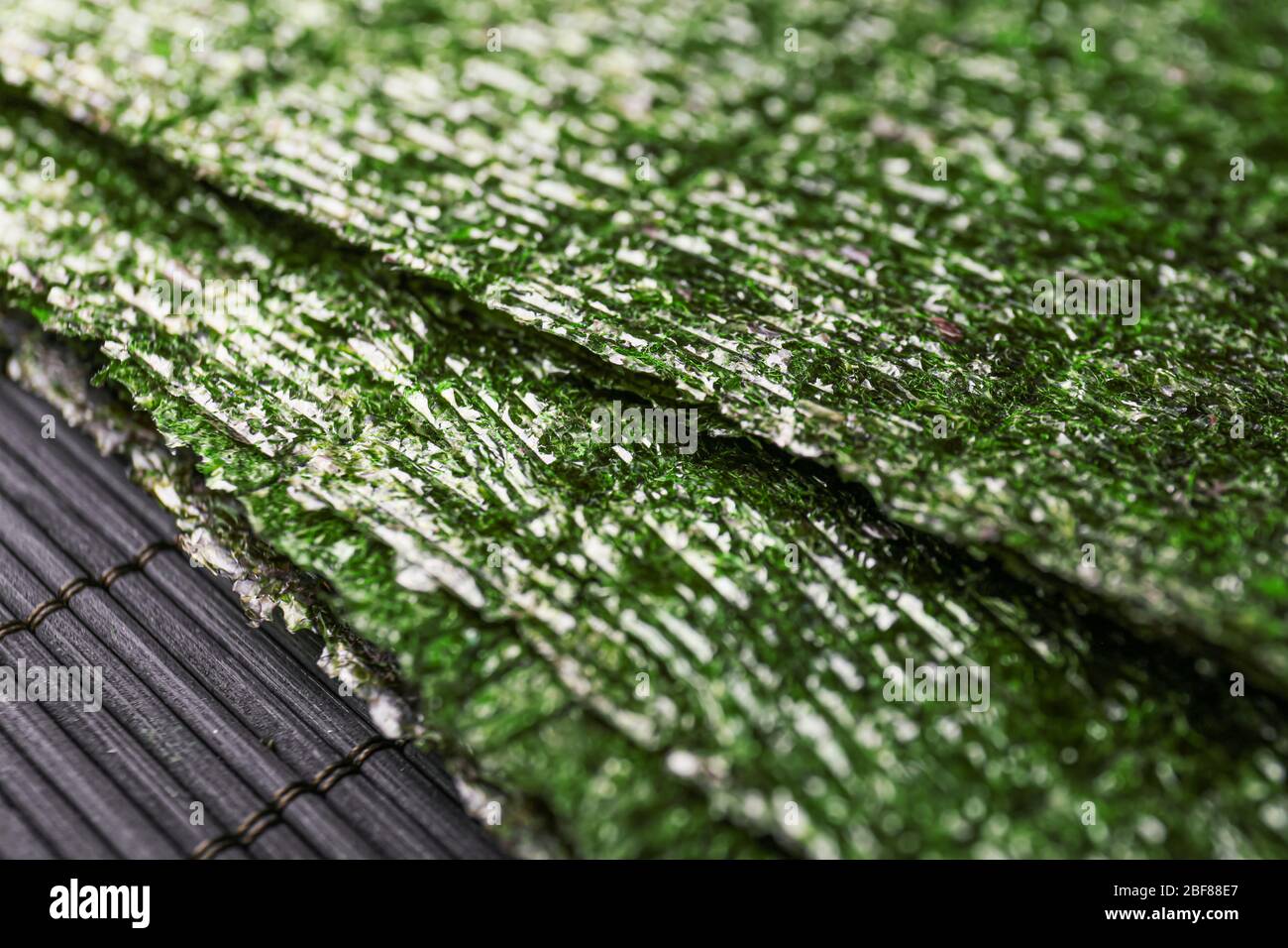 Tasty seaweed sheets on table, closeup Stock Photo - Alamy