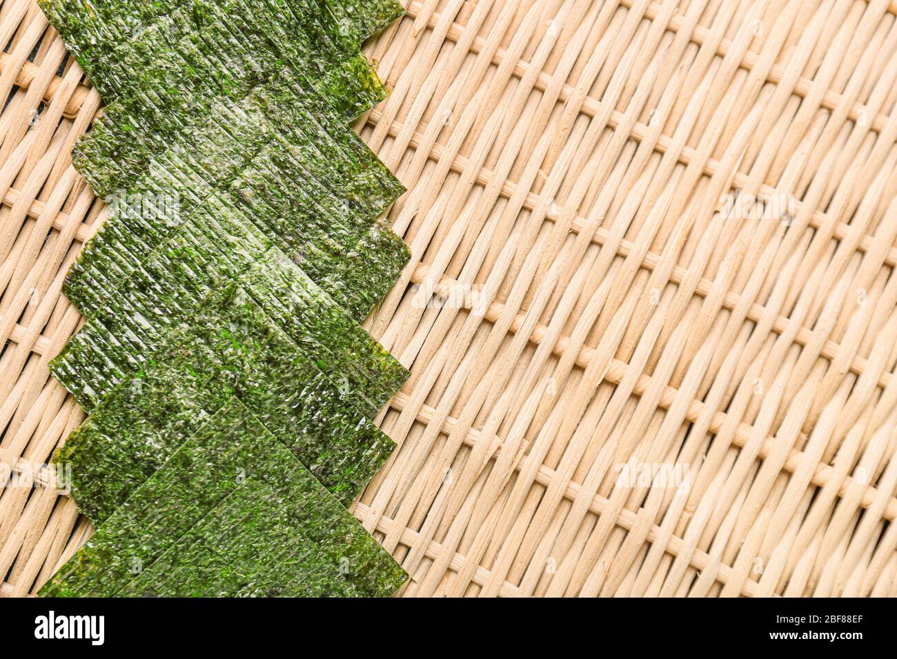Tasty seaweed sheets on bamboo mat Stock Photo - Alamy