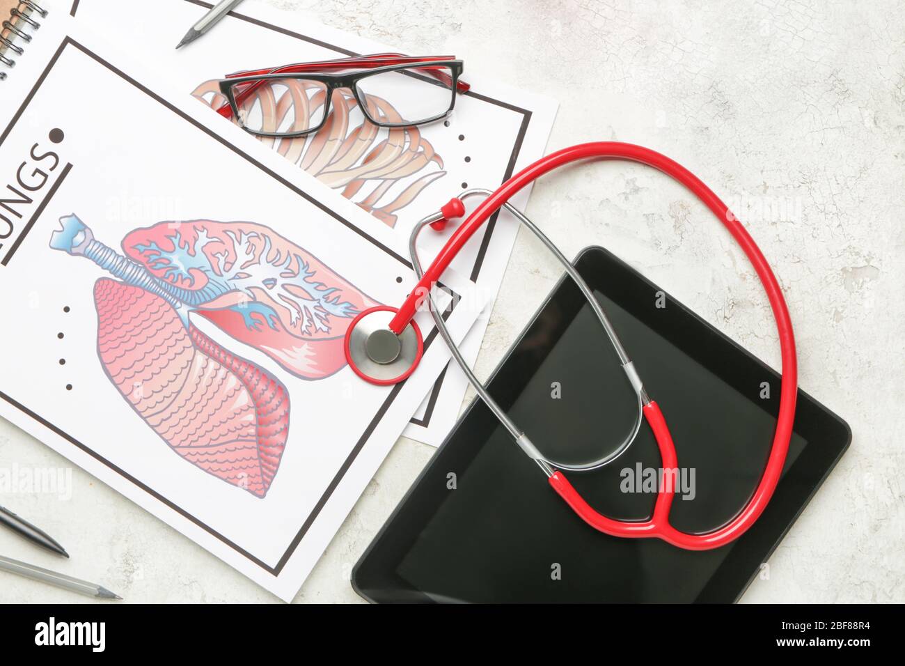Stethoscope with tablet computer, drawings of human ribs and lungs on ...