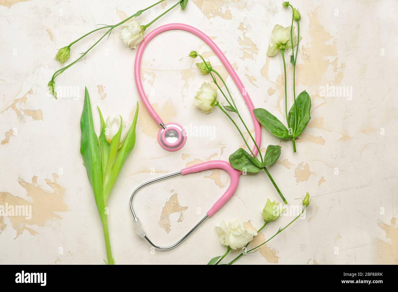 Stethoscope with flowers on white background Stock Photo - Alamy