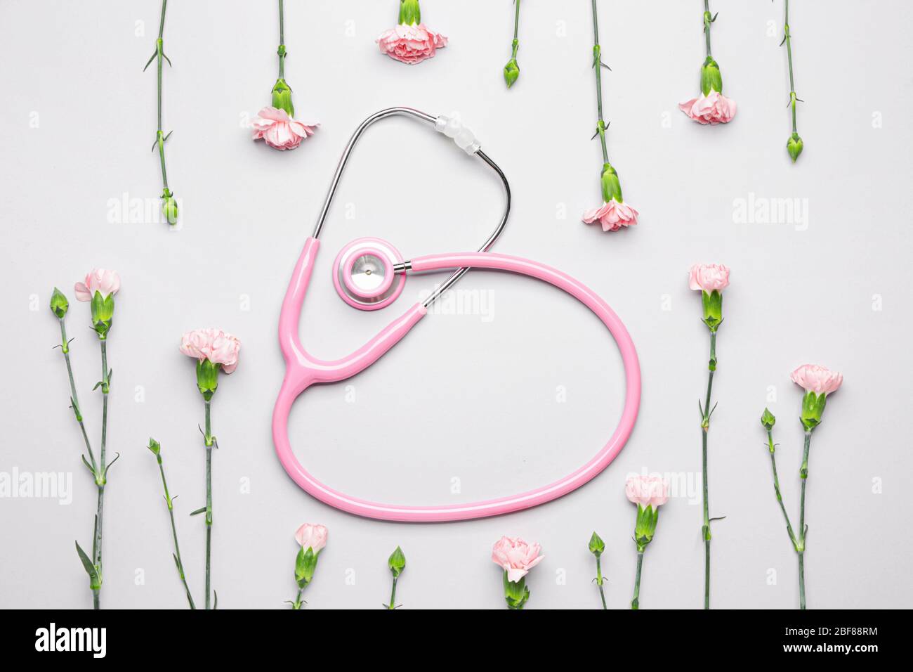 Stethoscope with flowers on white background Stock Photo - Alamy