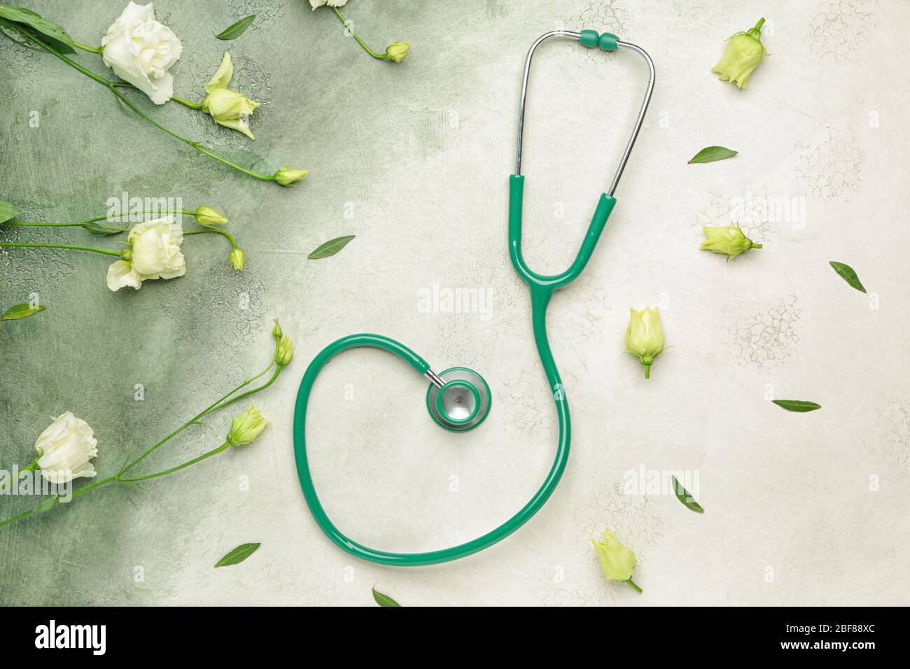 Stethoscope with flowers on color background Stock Photo - Alamy