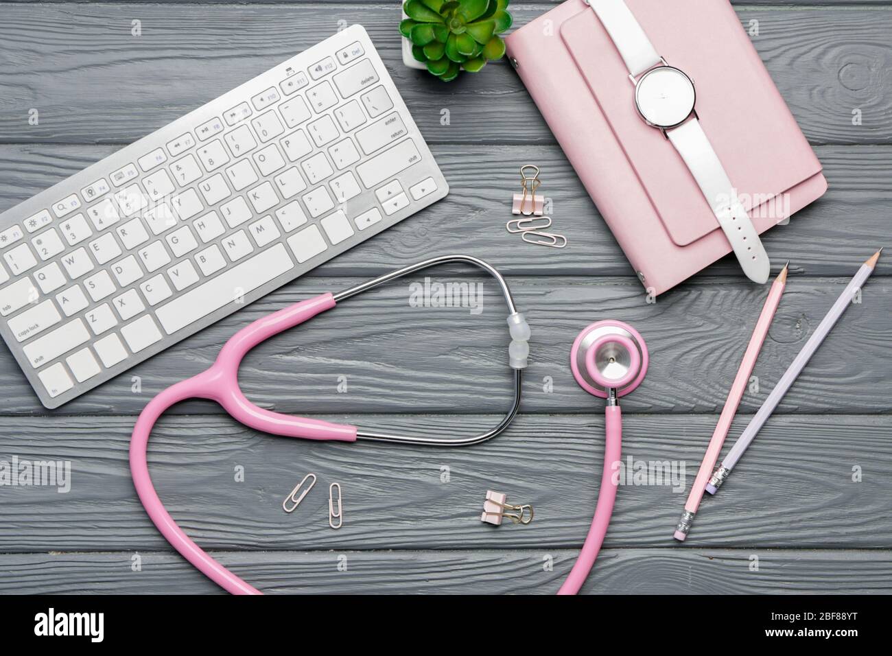 Stethoscope with computer keyboard and stationery on wooden table Stock ...